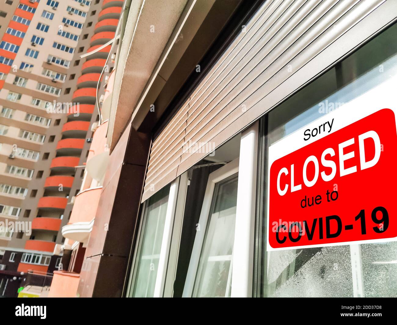 Business center closed due to COVID-19, sign with sorry in door window ...