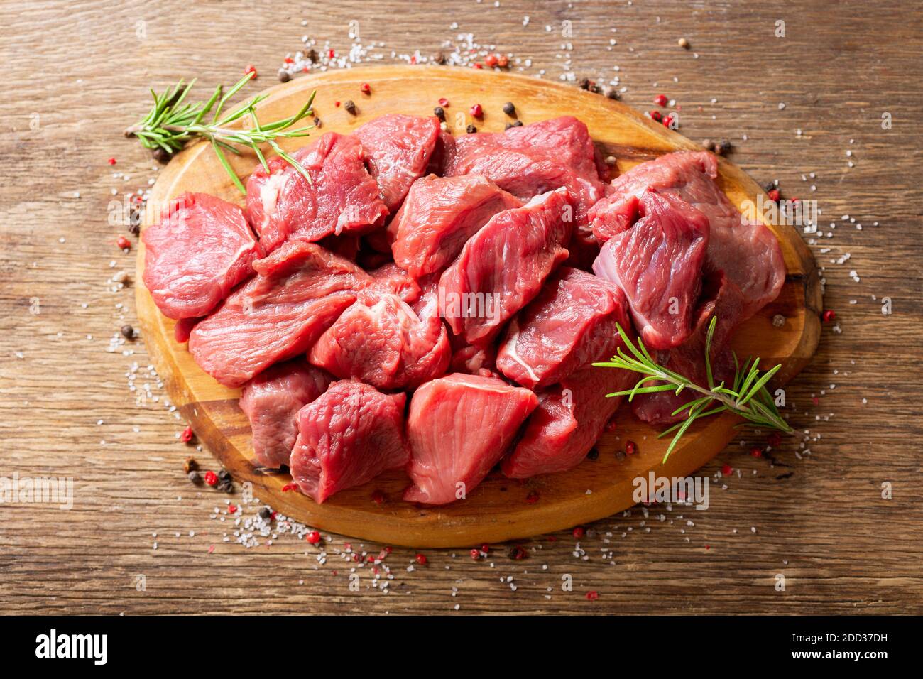 fresh chopped meat with rosemary on wooden board, top view Stock Photo ...