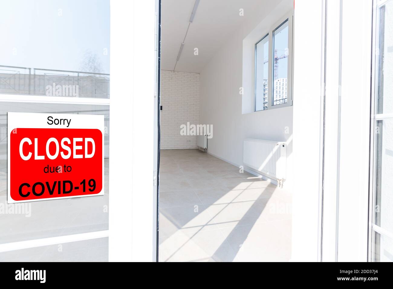 Business center closed due to COVID-19, sign with sorry in door window ...