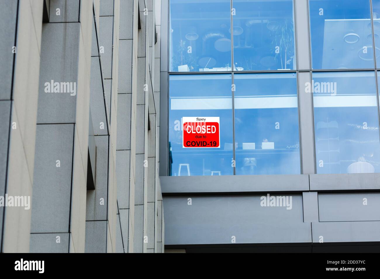 Business center closed due to COVID-19, sign with sorry in door window ...