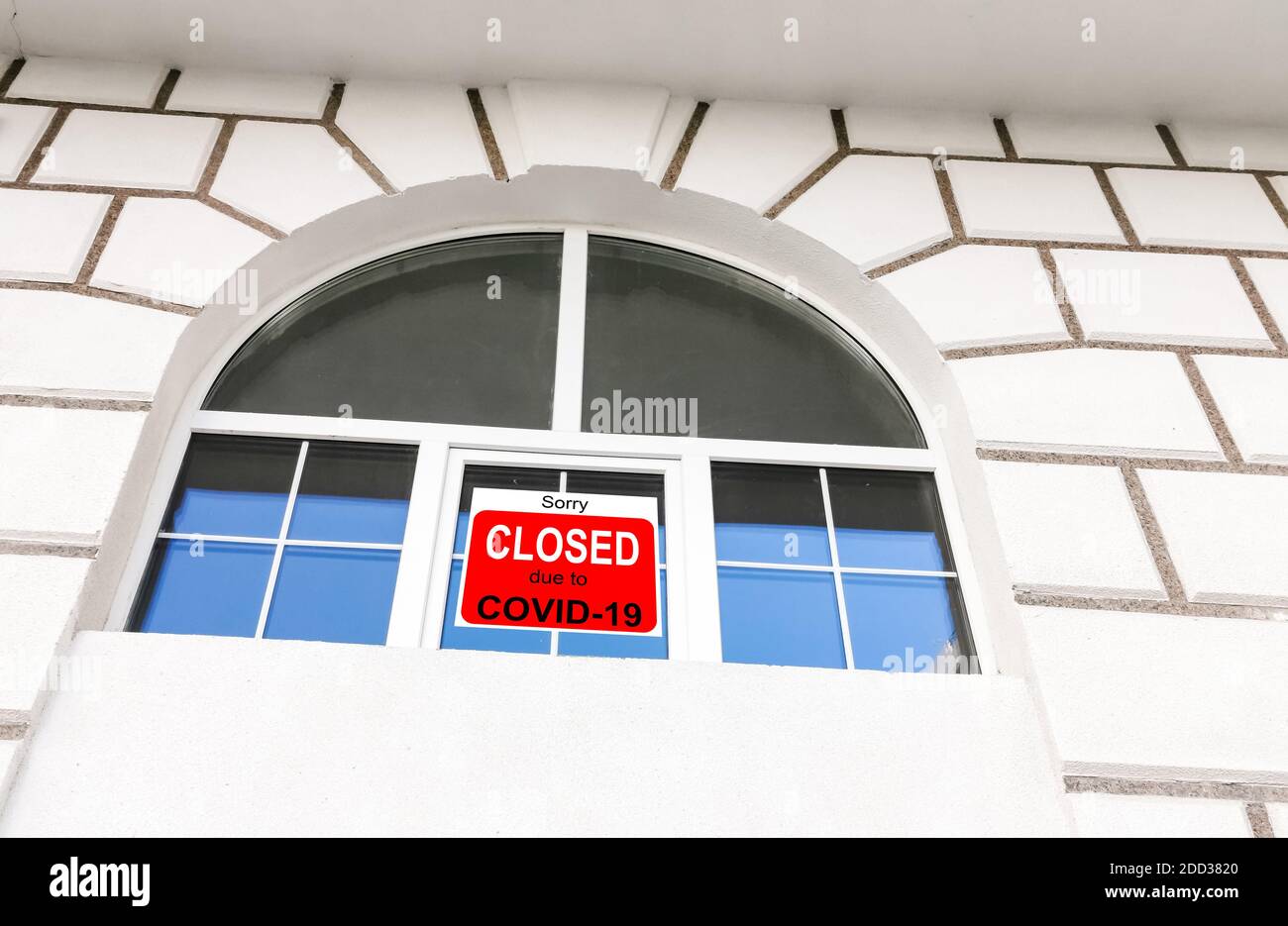 Business center closed due to COVID-19, sign with sorry in door window ...