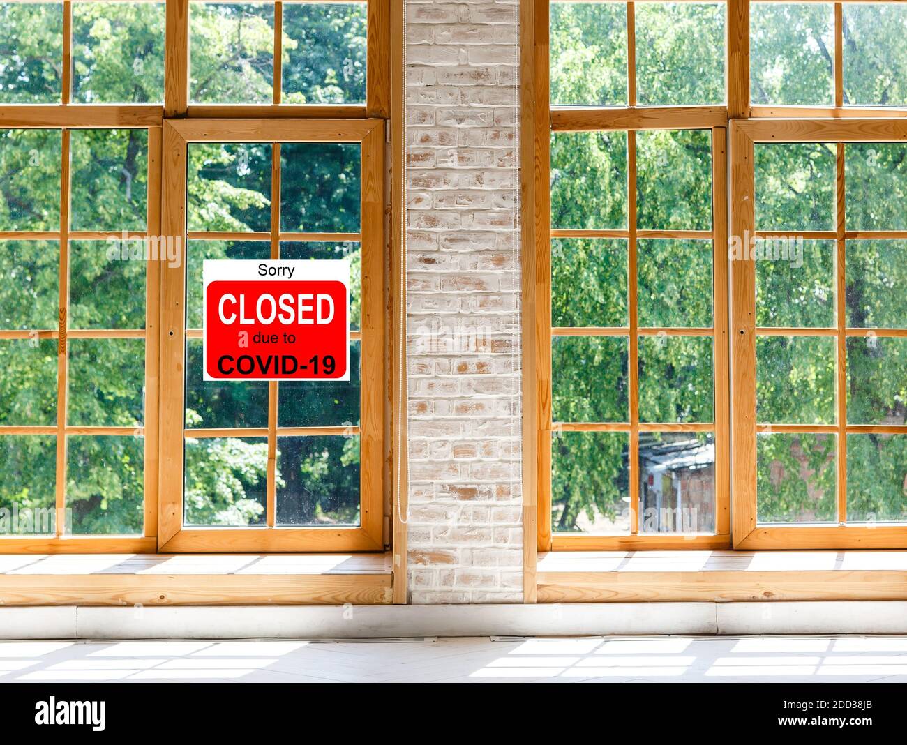 Business center closed due to COVID-19, sign with sorry in door window ...