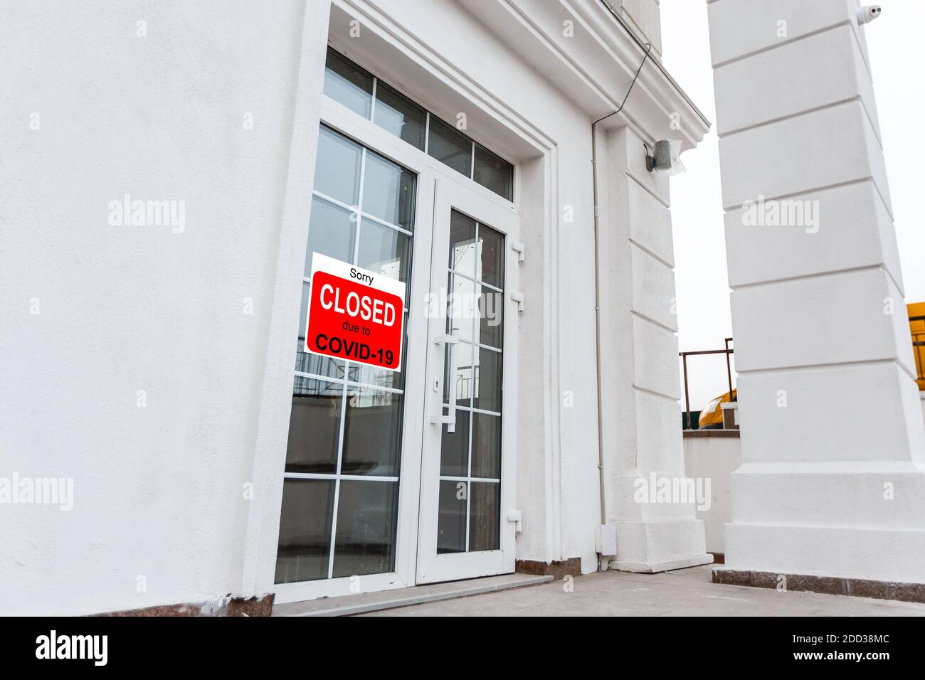 Business center closed due to COVID-19, sign with sorry in door window ...