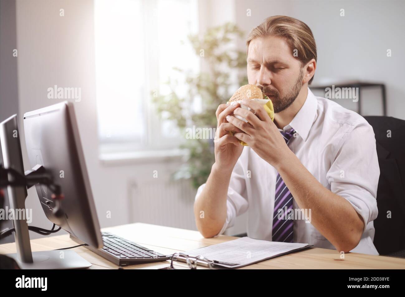 Eating junk food businessman hi-res stock photography and images - Alamy
