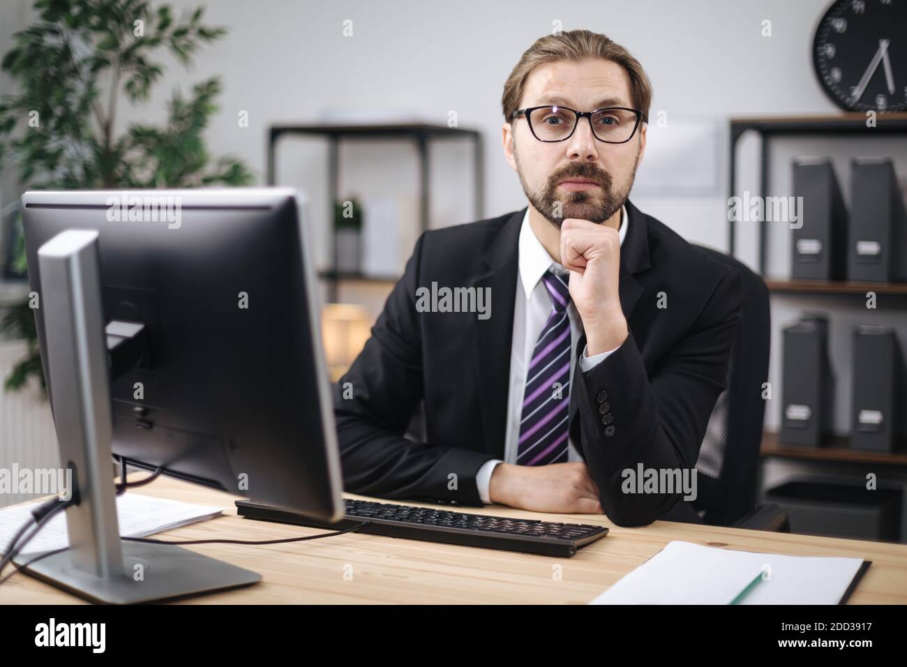 Confident businessman using computer at work Stock Photo - Alamy