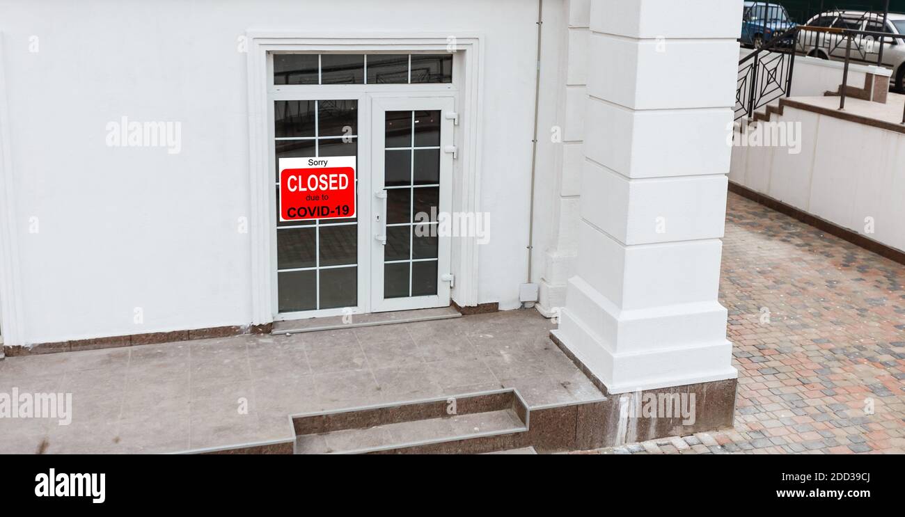 Business center closed due to COVID-19, sign with sorry in door window ...