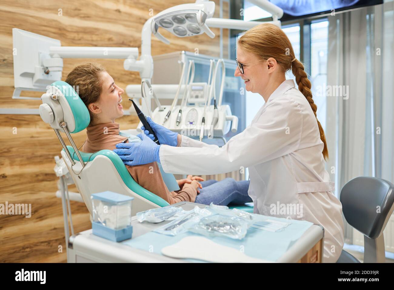 Dentist doing dental hygiene to patient at dental clinic Stock Photo ...