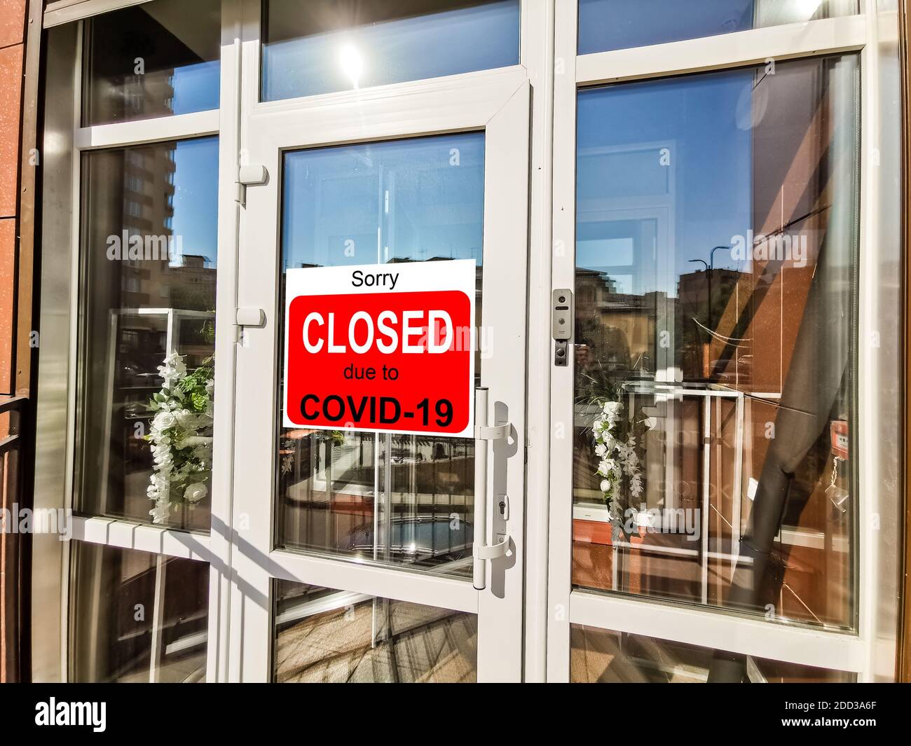 Business center closed due to COVID-19, sign with sorry in door window ...