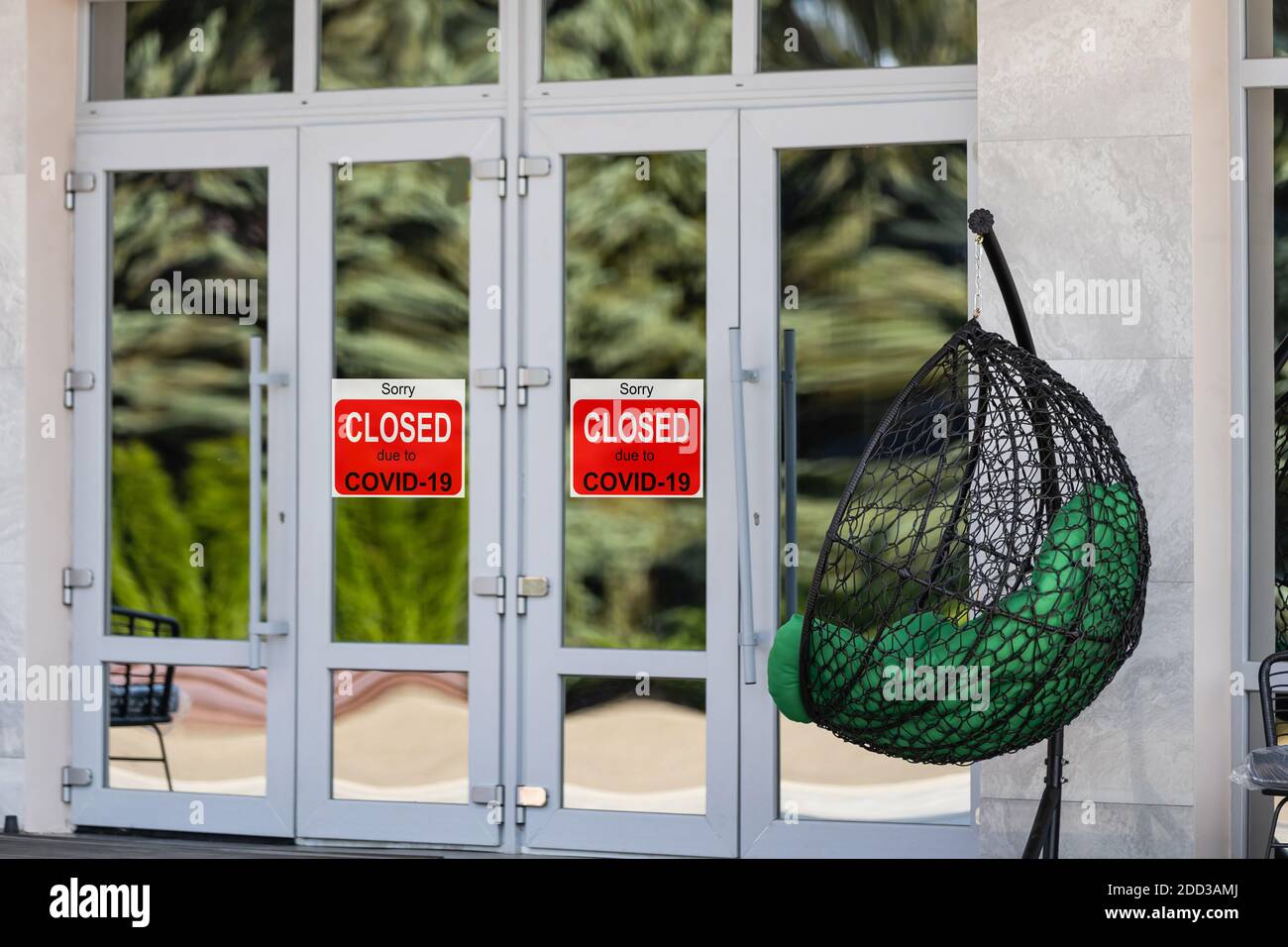 Business center closed due to COVID-19, sign with sorry in door window ...