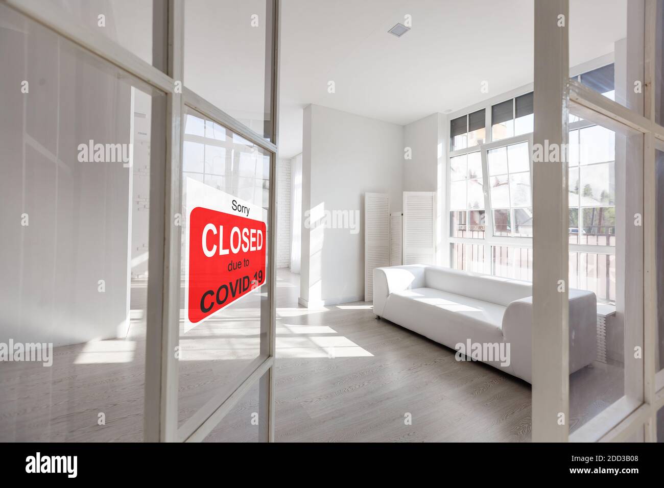 Business center closed due to COVID-19, sign with sorry in door window ...