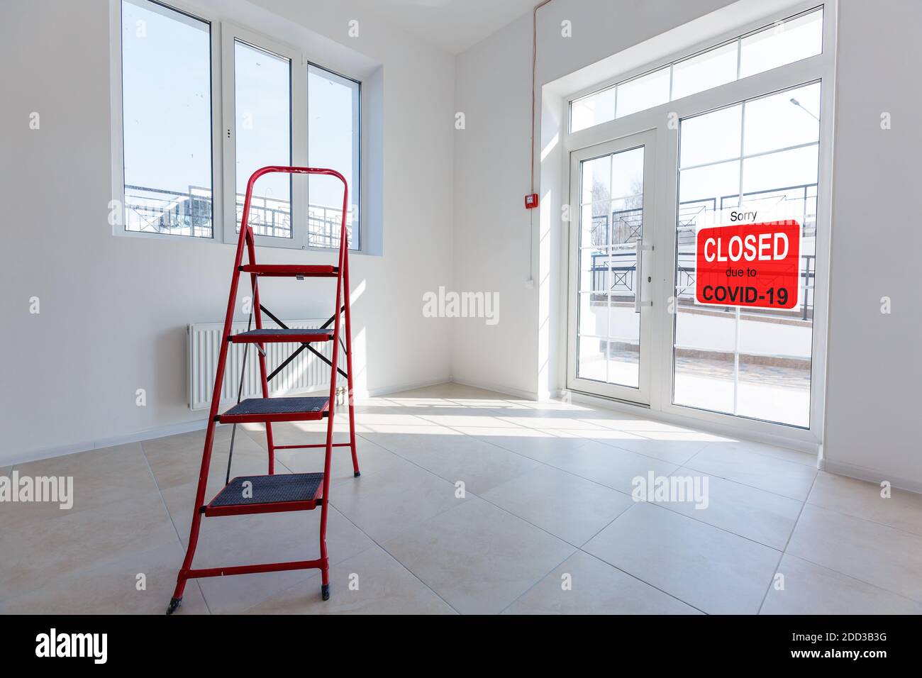 Business center closed due to COVID-19, sign with sorry in door window ...