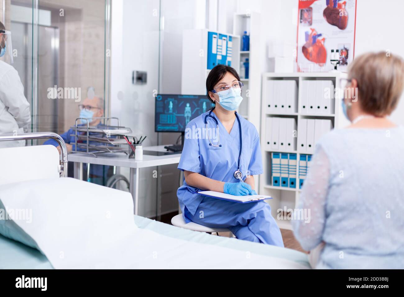Nurse wearing face mask asgainst covid during medical consultation of ...