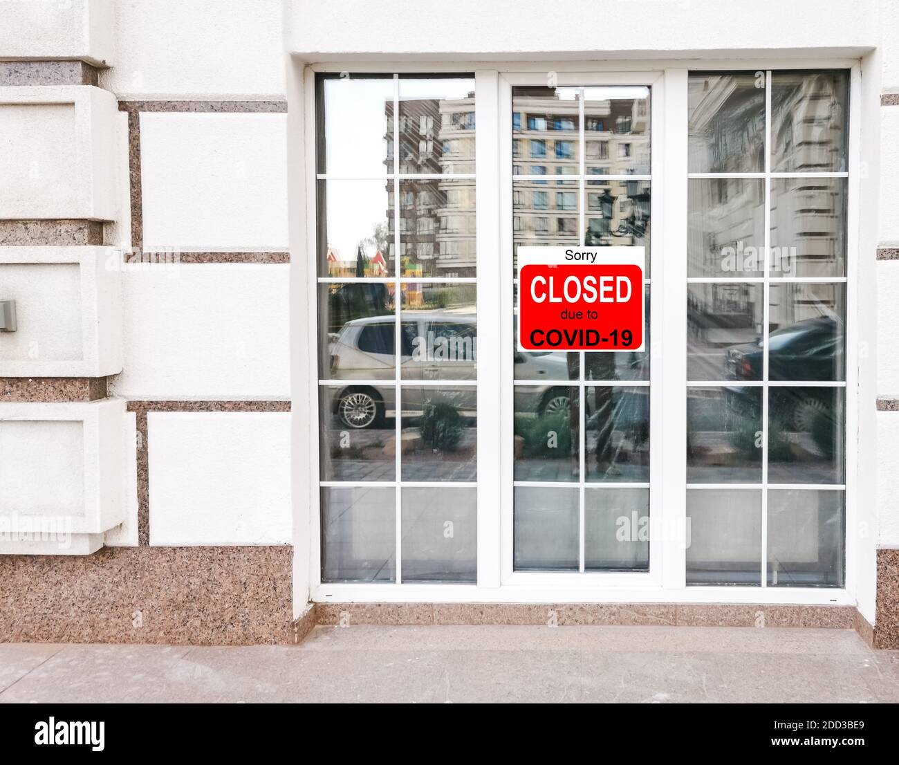 Business center closed due to COVID-19, sign with sorry in door window ...