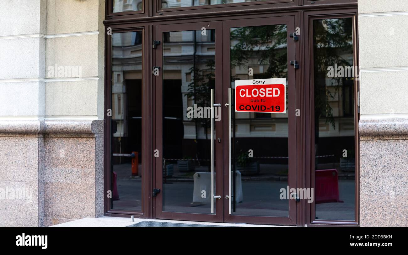 Business center closed due to COVID-19, sign with sorry in door window ...
