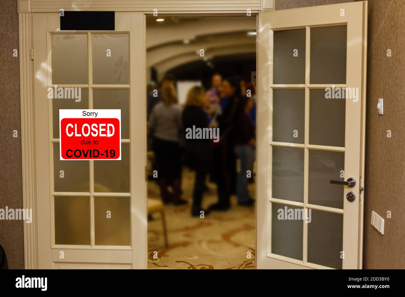 Business center closed due to COVID-19, sign with sorry in door window ...