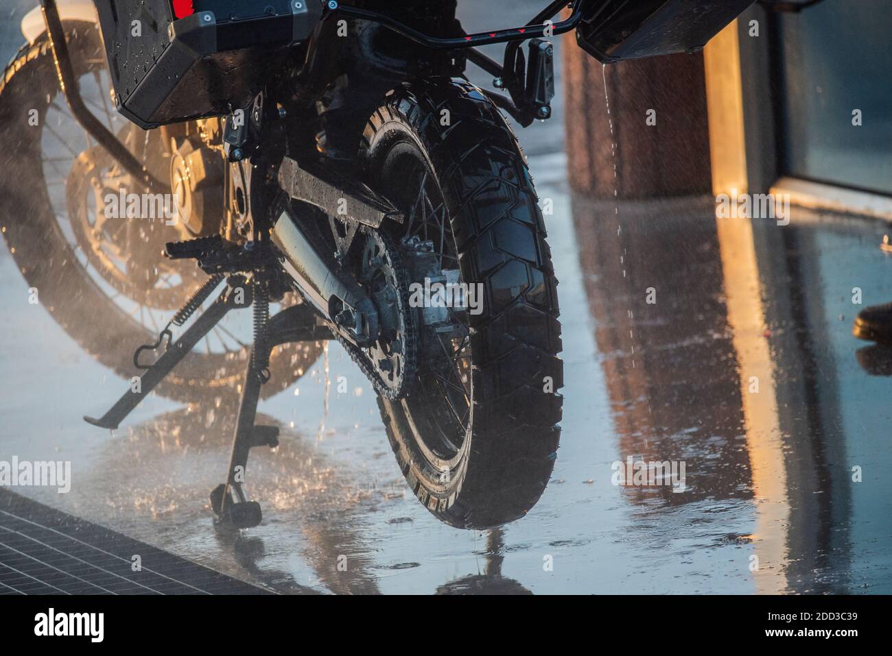 Motorbike washing series. Washing a motorcycle at a car wash at sunset ...
