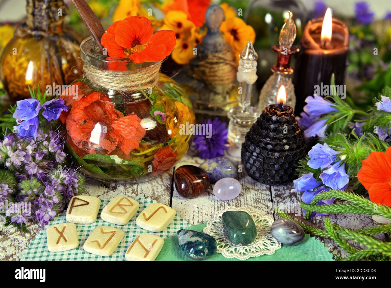 Still life with reiki crystals, runes, black candles and witch herbal ...