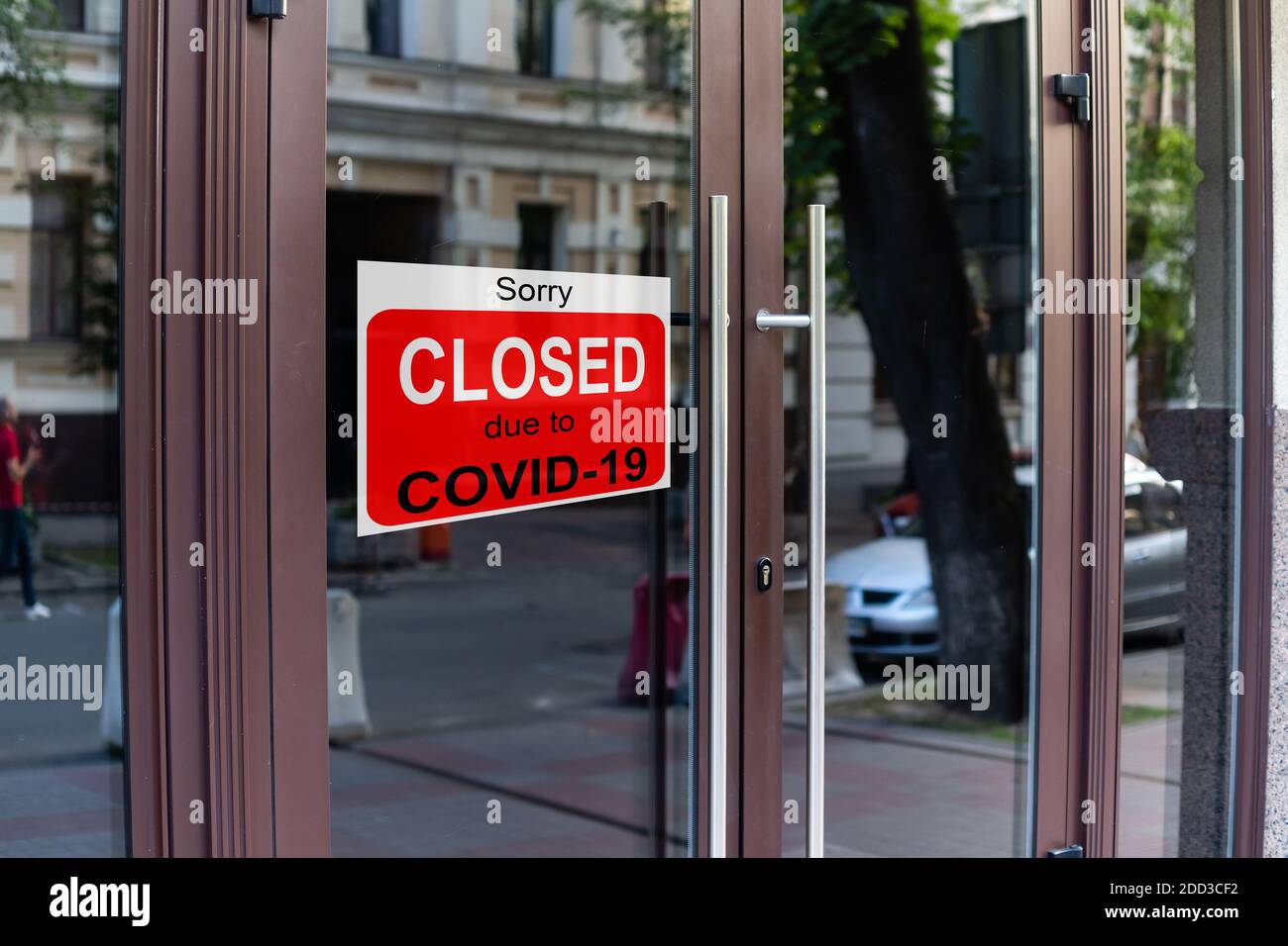 Business center closed due to COVID-19, sign with sorry in door window ...