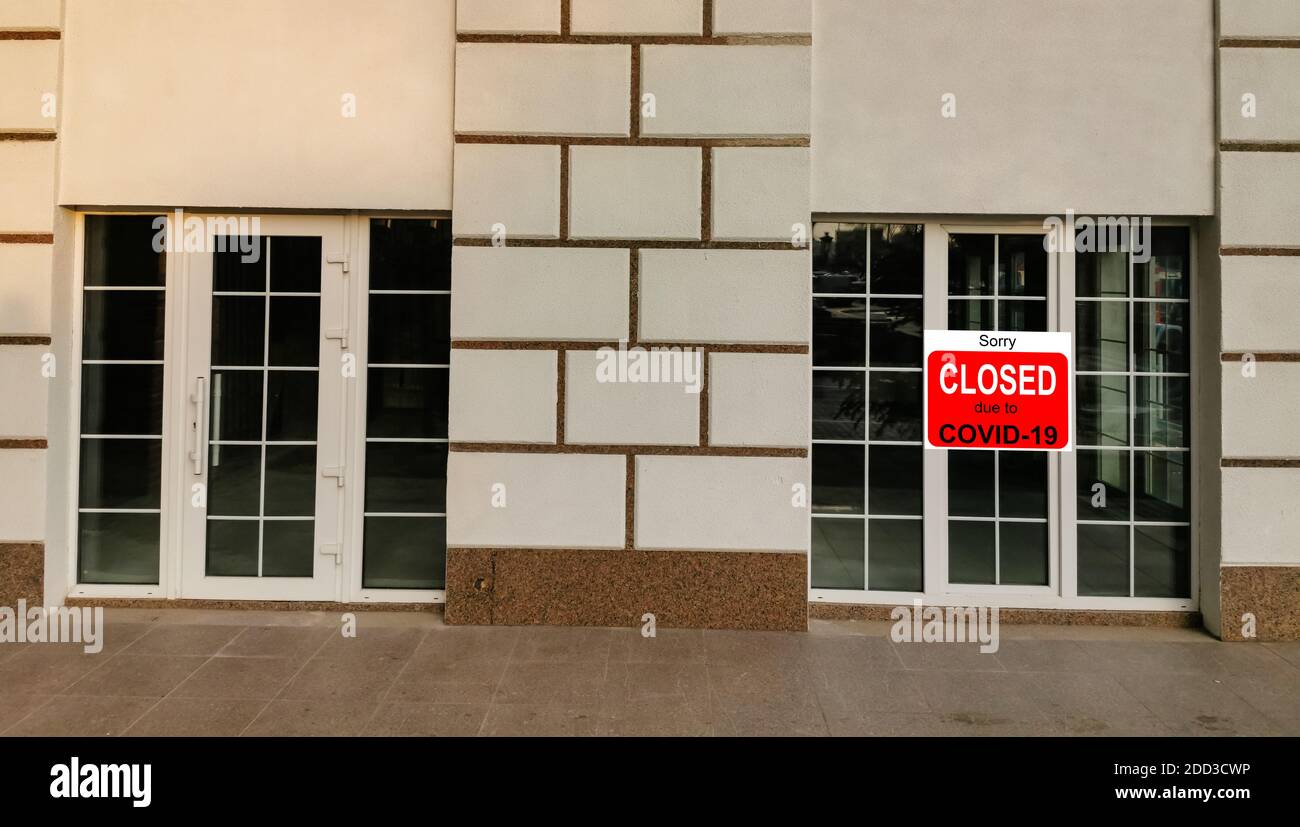 Business center closed due to COVID-19, sign with sorry in door window ...