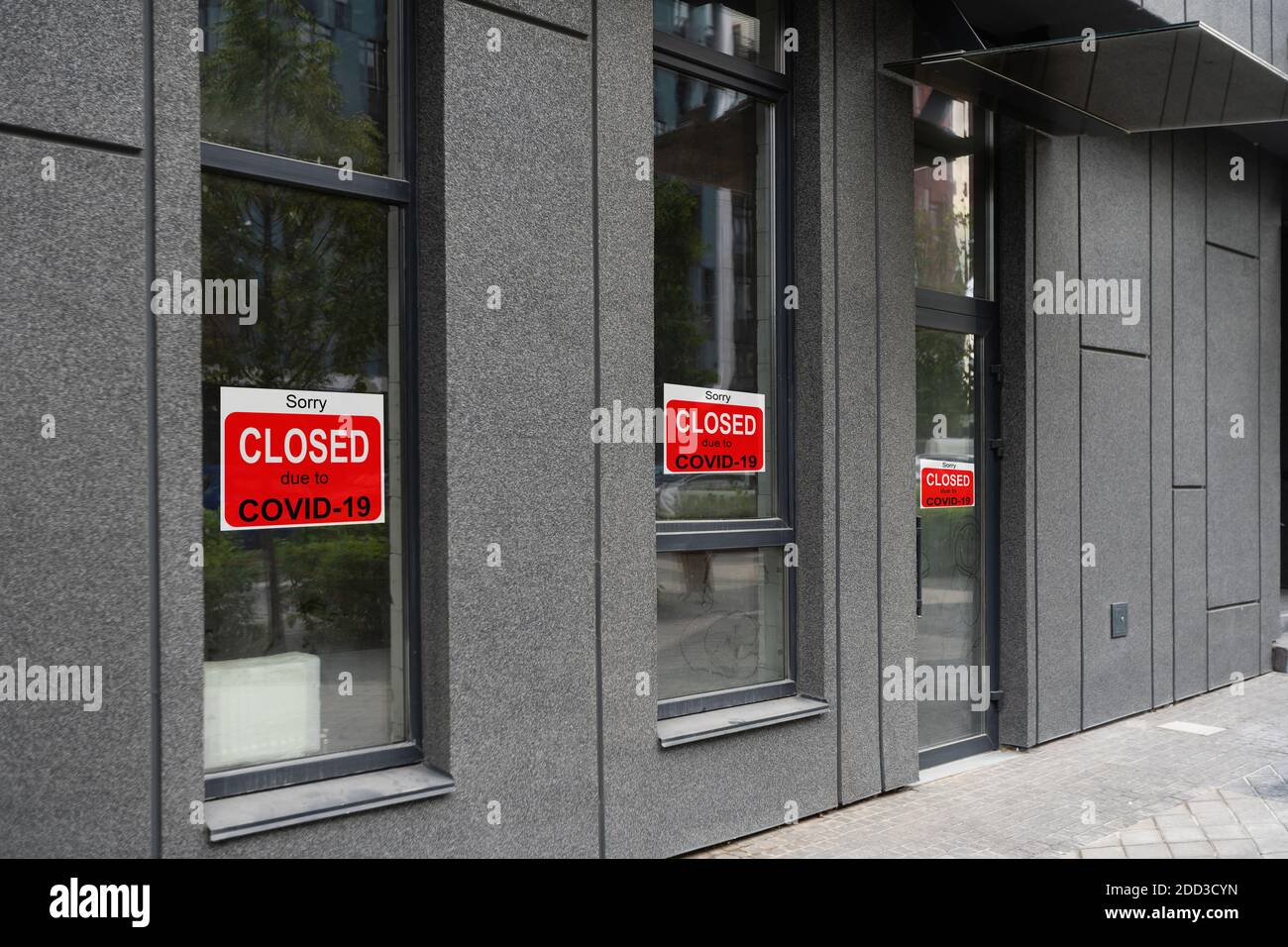 Business center closed due to COVID-19, sign with sorry in door window ...