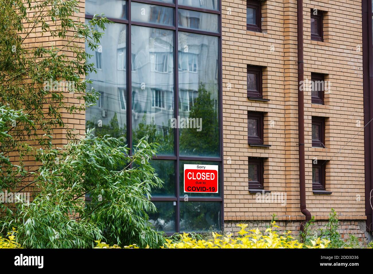 Business center closed due to COVID-19, sign with sorry in door window ...
