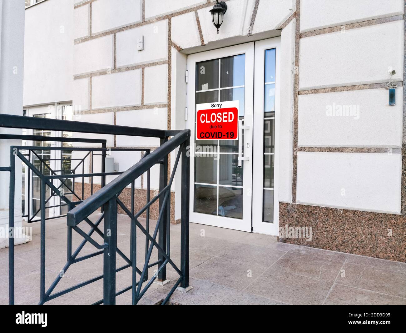 Business center closed due to COVID-19, sign with sorry in door window ...
