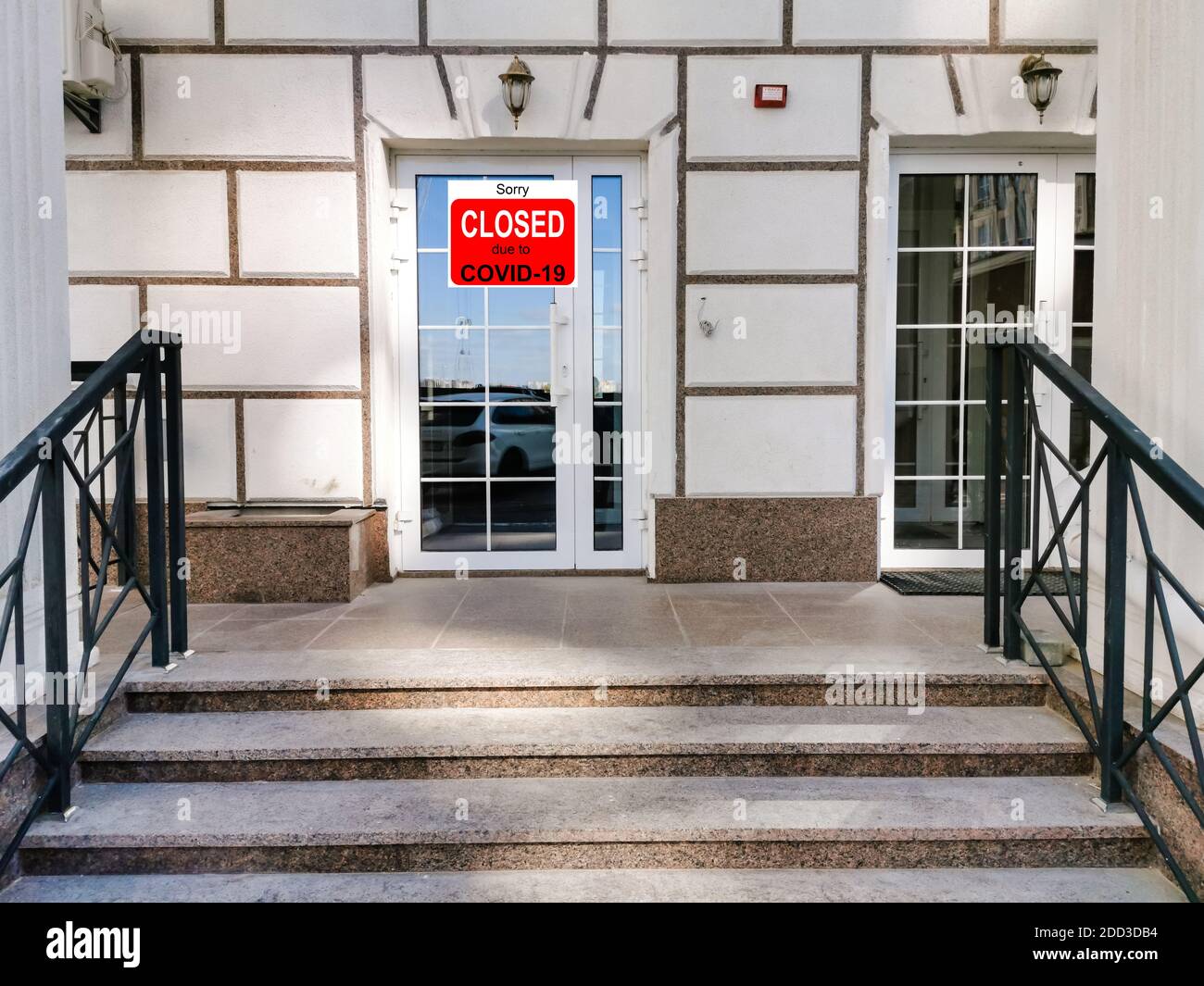 Business center closed due to COVID-19, sign with sorry in door window ...