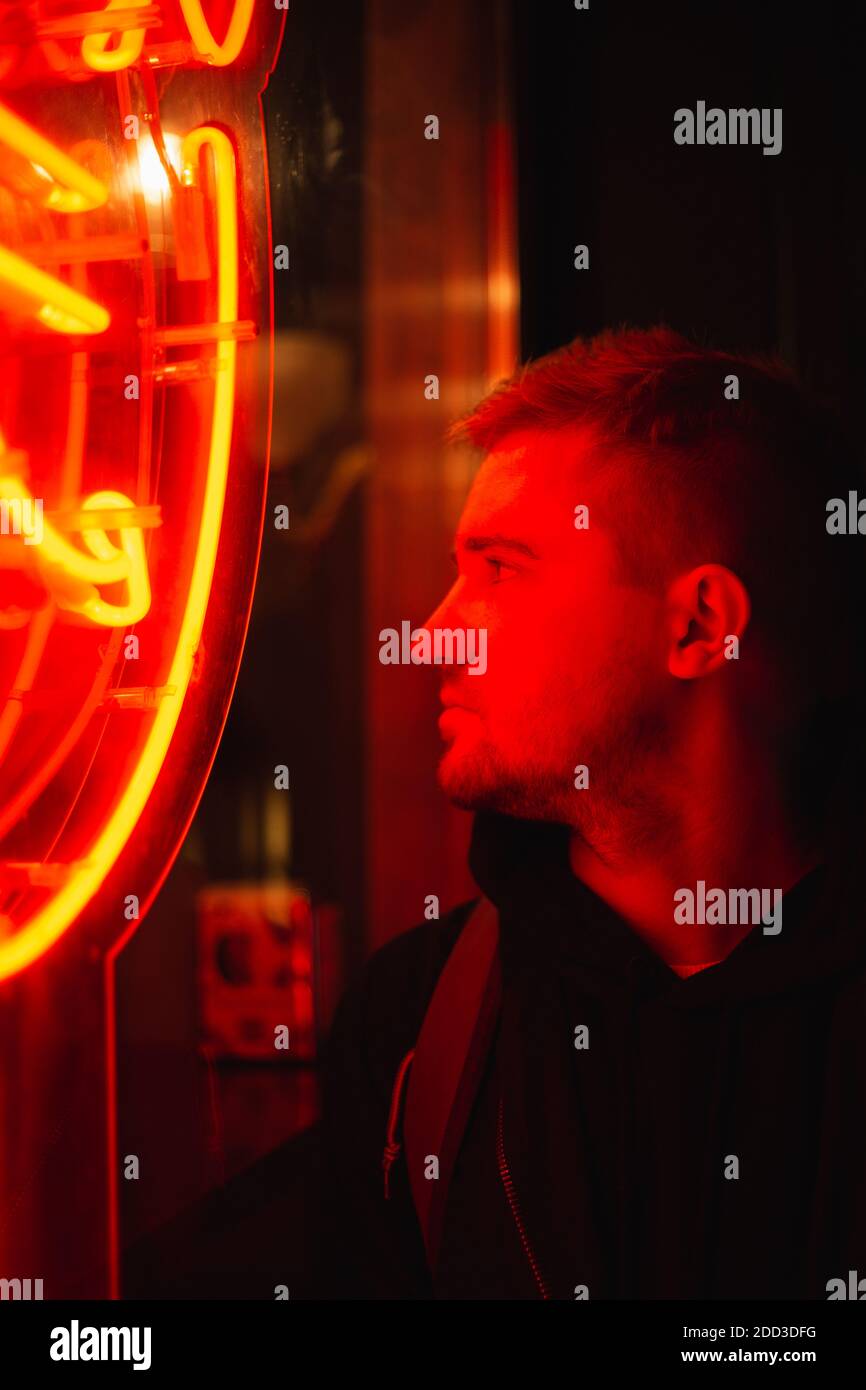 Handsome man's portrait with neon red lights at night Stock Photo - Alamy