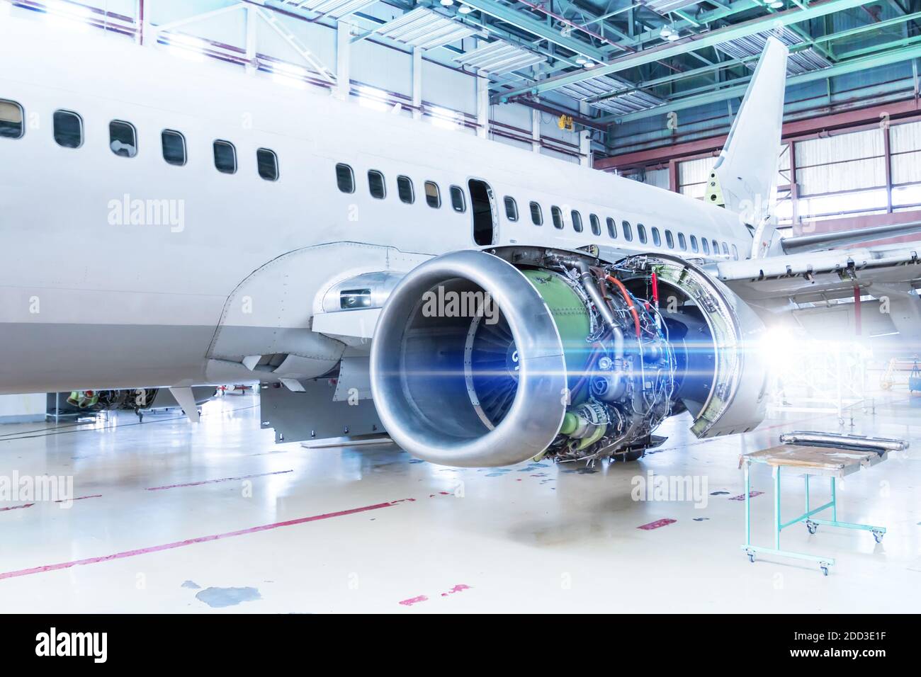 White passenger airplane under maintenance in the hangar. Repair of ...