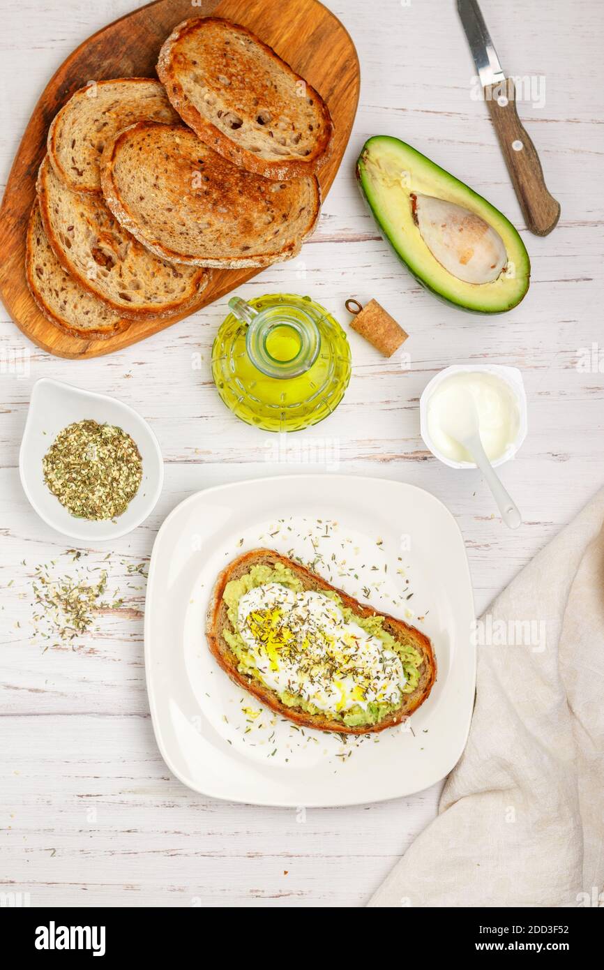 Toast of rye bread with avocado (guacamole), Greek yogurt, seasonings ...
