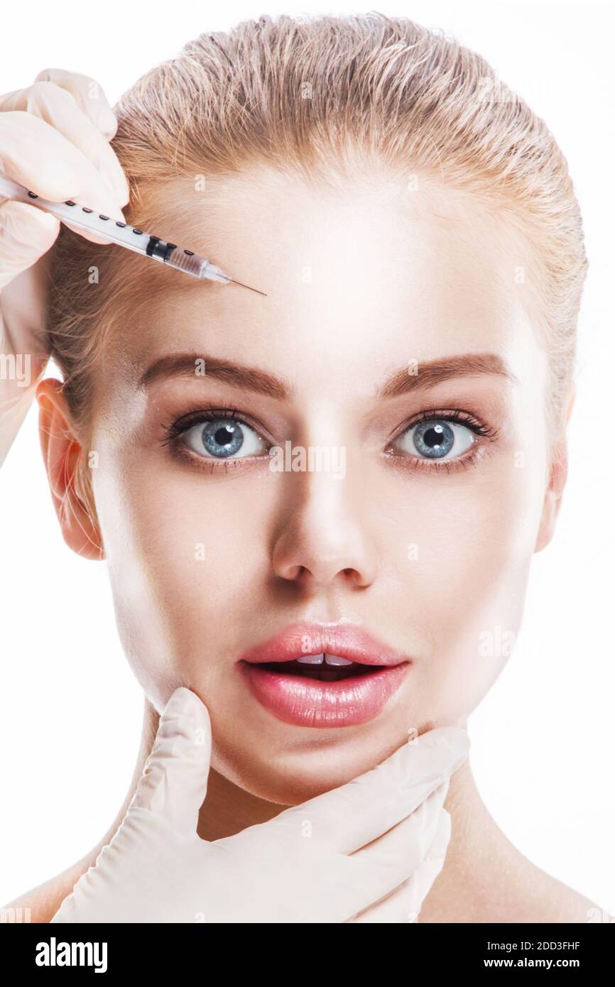Cosmetologist making beauty shots with syringe for a beautiful, young ...