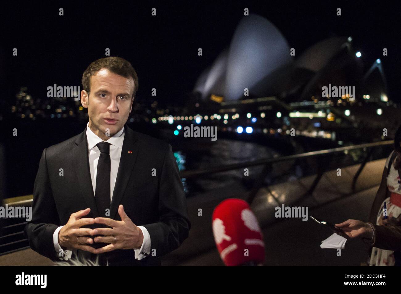 France's President Emmanuel Macron speaks to media as he walks along ...