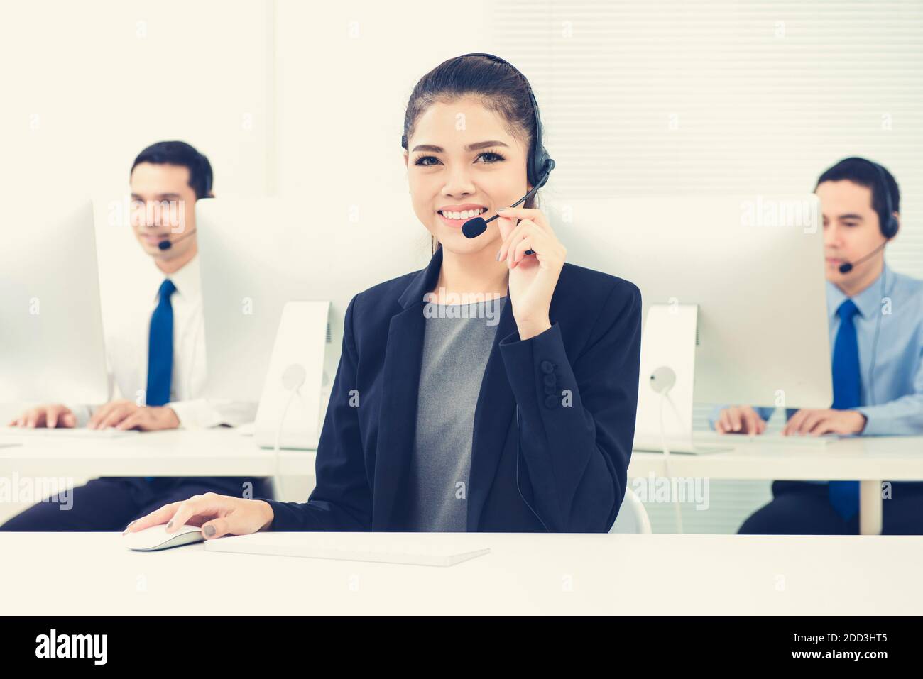 Young Asian woman as an operator working in call center, vintage tone ...