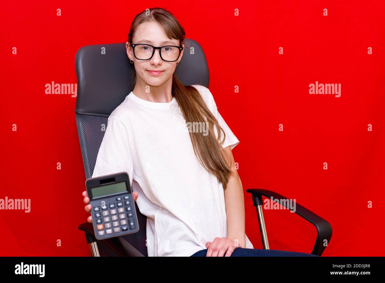 Young surprised caucasian girl counting calculator. Education concept ...