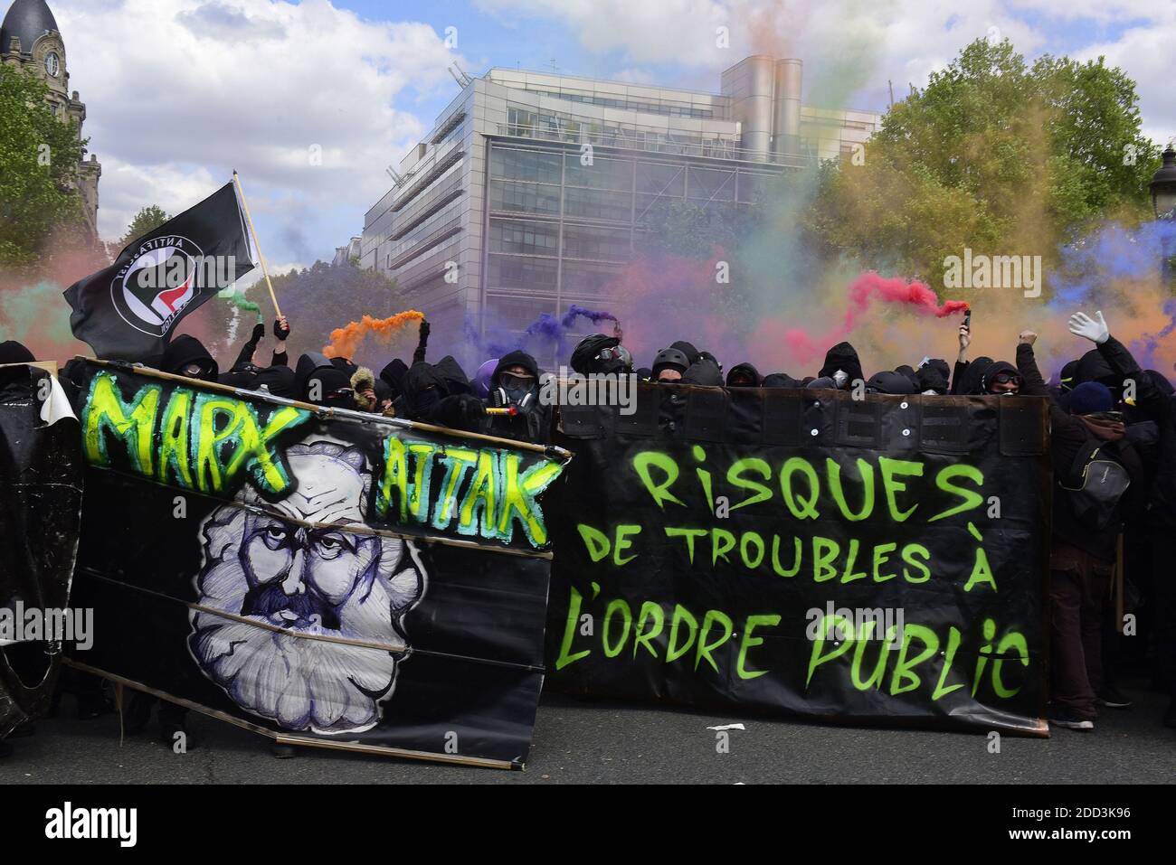 Young masked protesters the Black Blocs behind a banner reading 'Marx ...