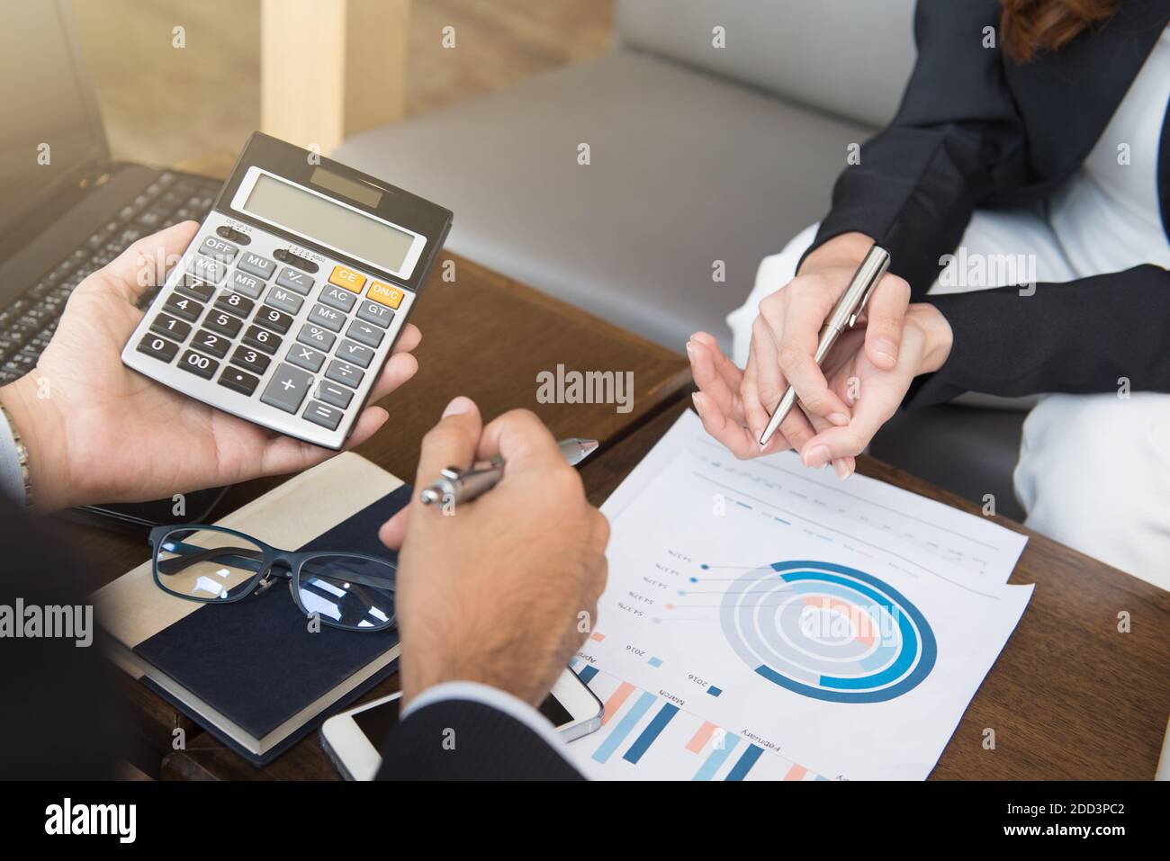 Financial adviser working with client, calculating and analyzing data ...