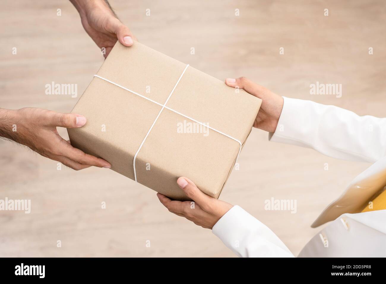 Woman hands receiving package from a man - delivery and courier ...
