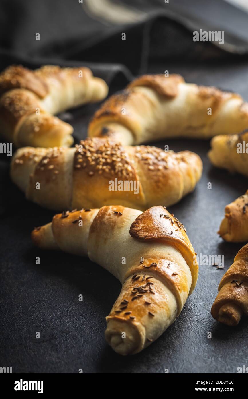Salted croissant bun roll. Homemade pastry on black table Stock Photo ...