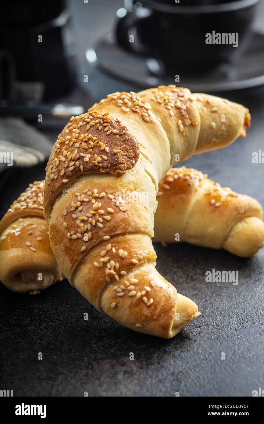 Salted croissant bun roll. Homemade pastry on black table Stock Photo ...