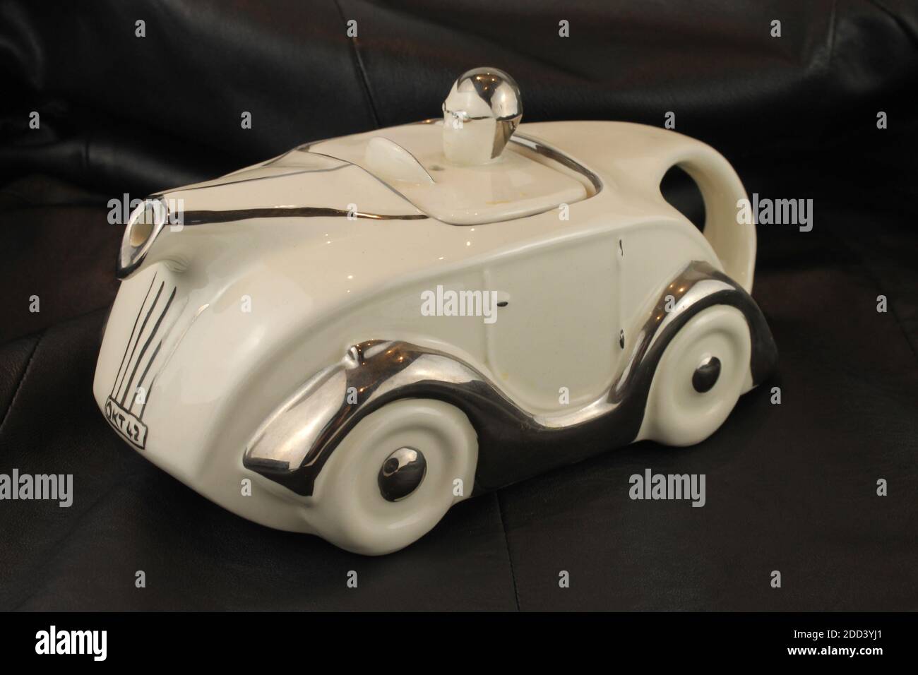 white ceramic racing car teapot isolated on a black background Stock ...