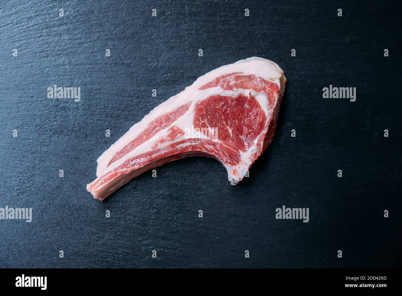 Raw and fresh lamb chop meat steaks on the black background Stock Photo ...
