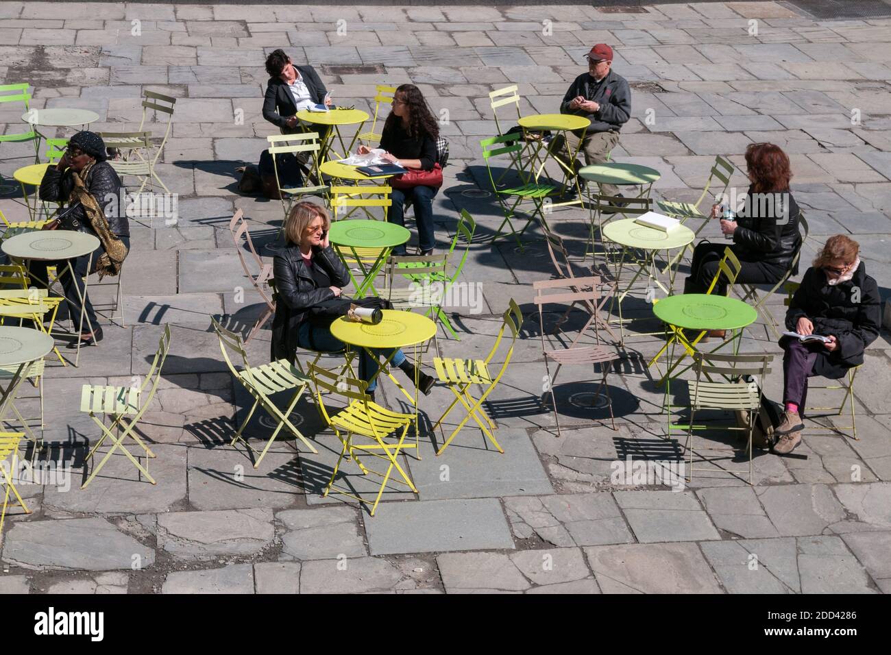 New York,USA:Some people are sitting in a plaza in downtown Brooklyn ...