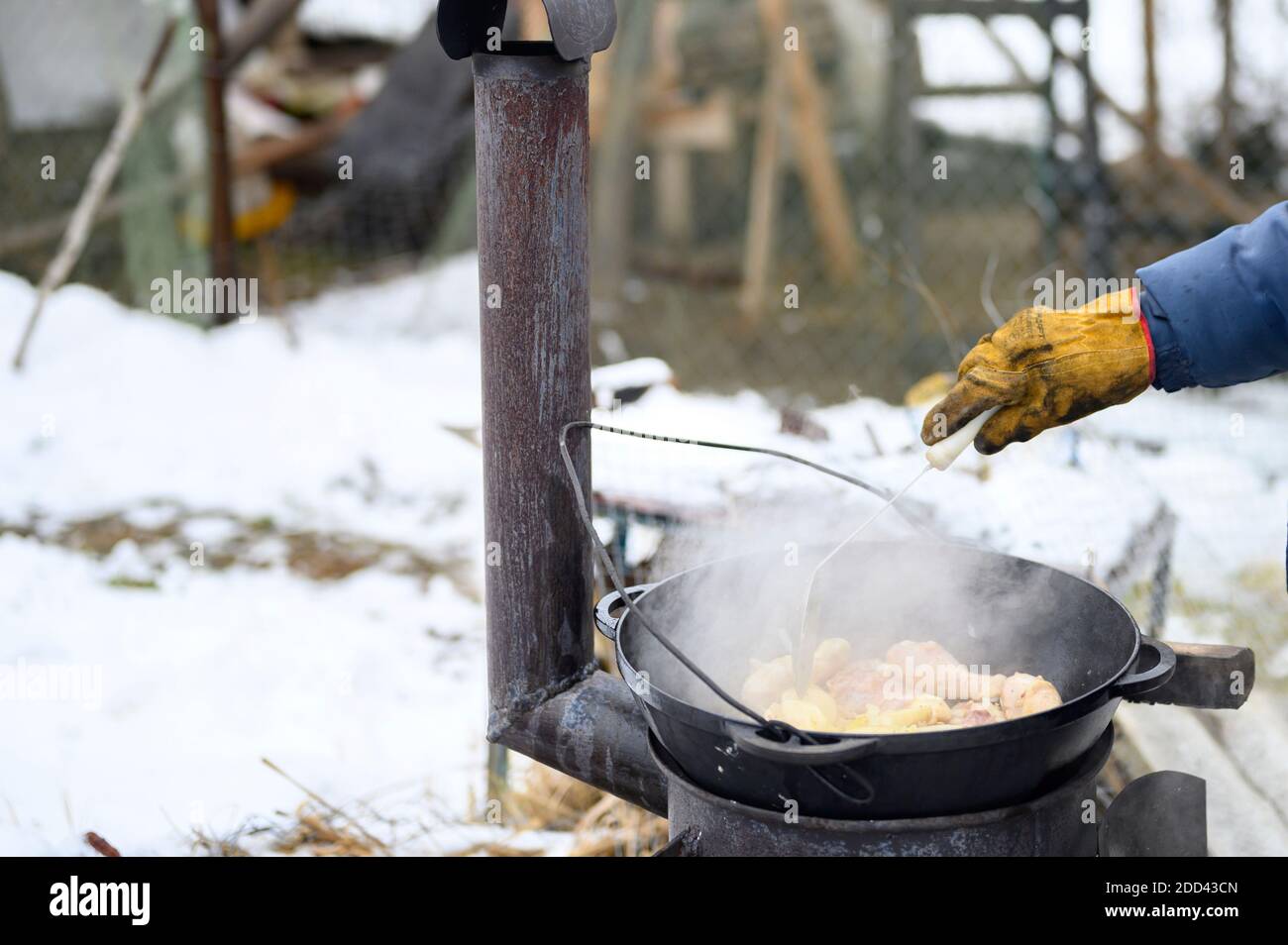 cooking in winter in a cauldron in the open air on a fire on a cast ...
