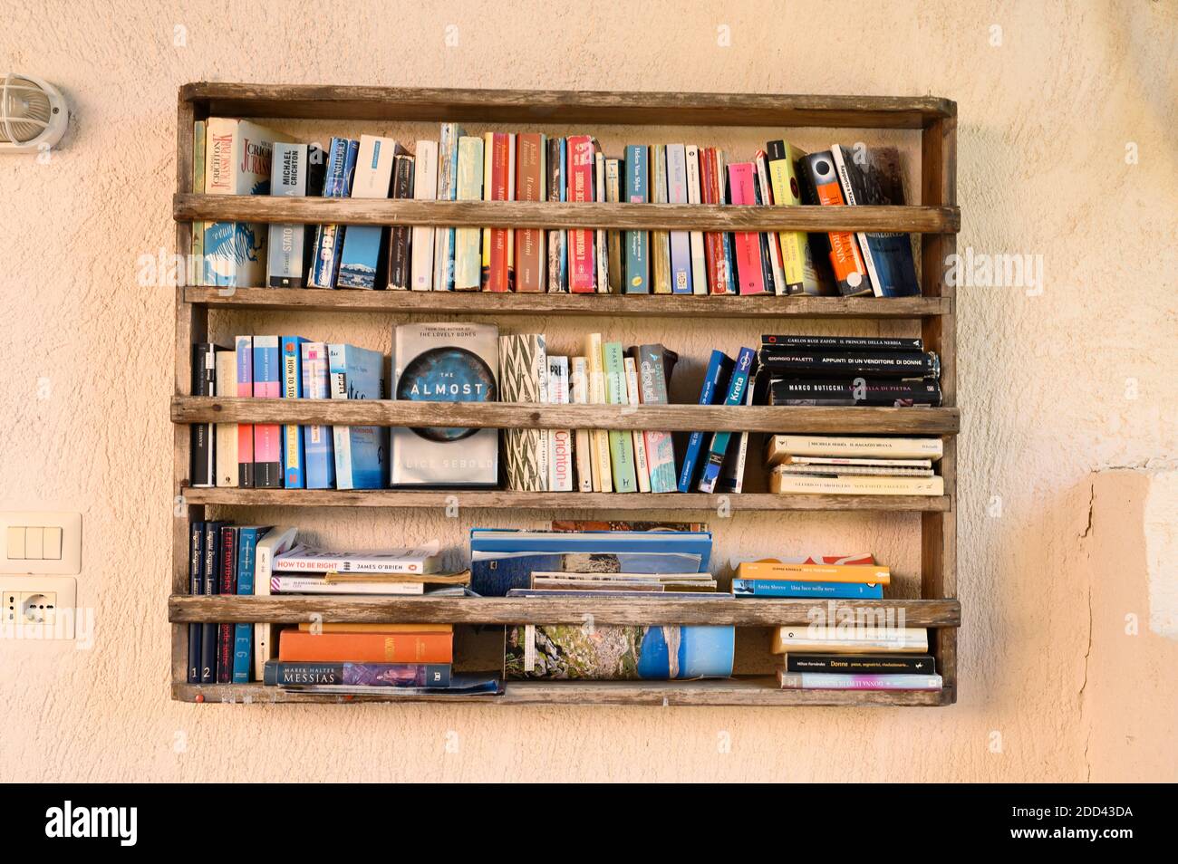 Crete / Greece - September 2019: bookshelf with books on the wall of ...