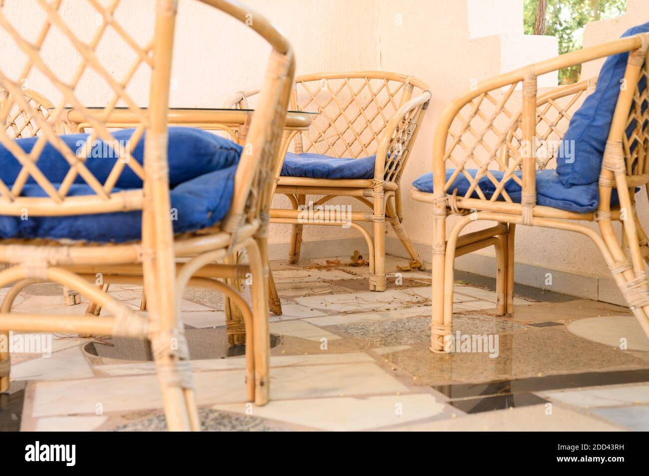 wicker wooden chairs and coffee table for relaxing and socializing with ...