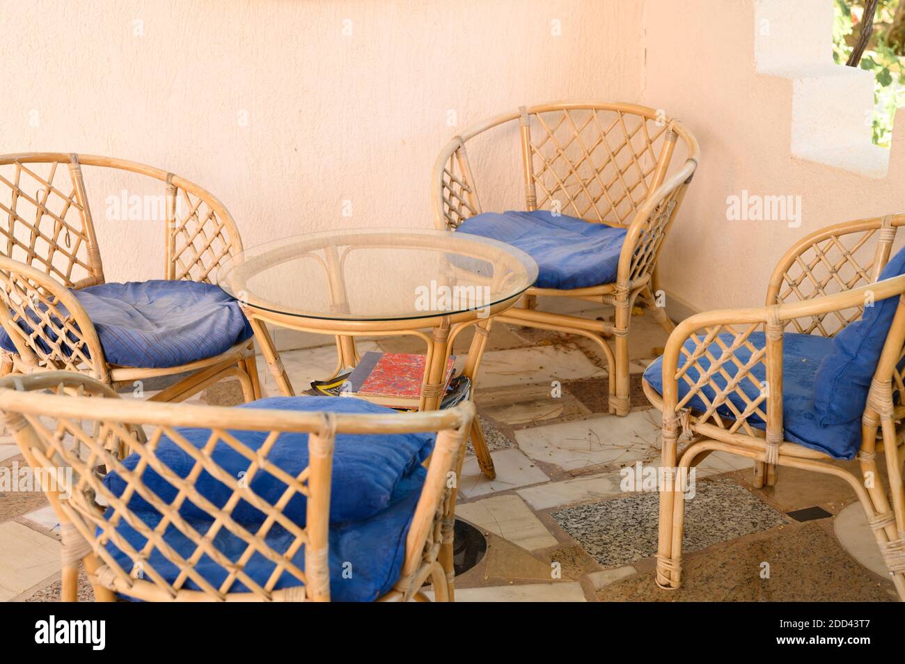 wicker wooden chairs and coffee table for relaxing and socializing with ...