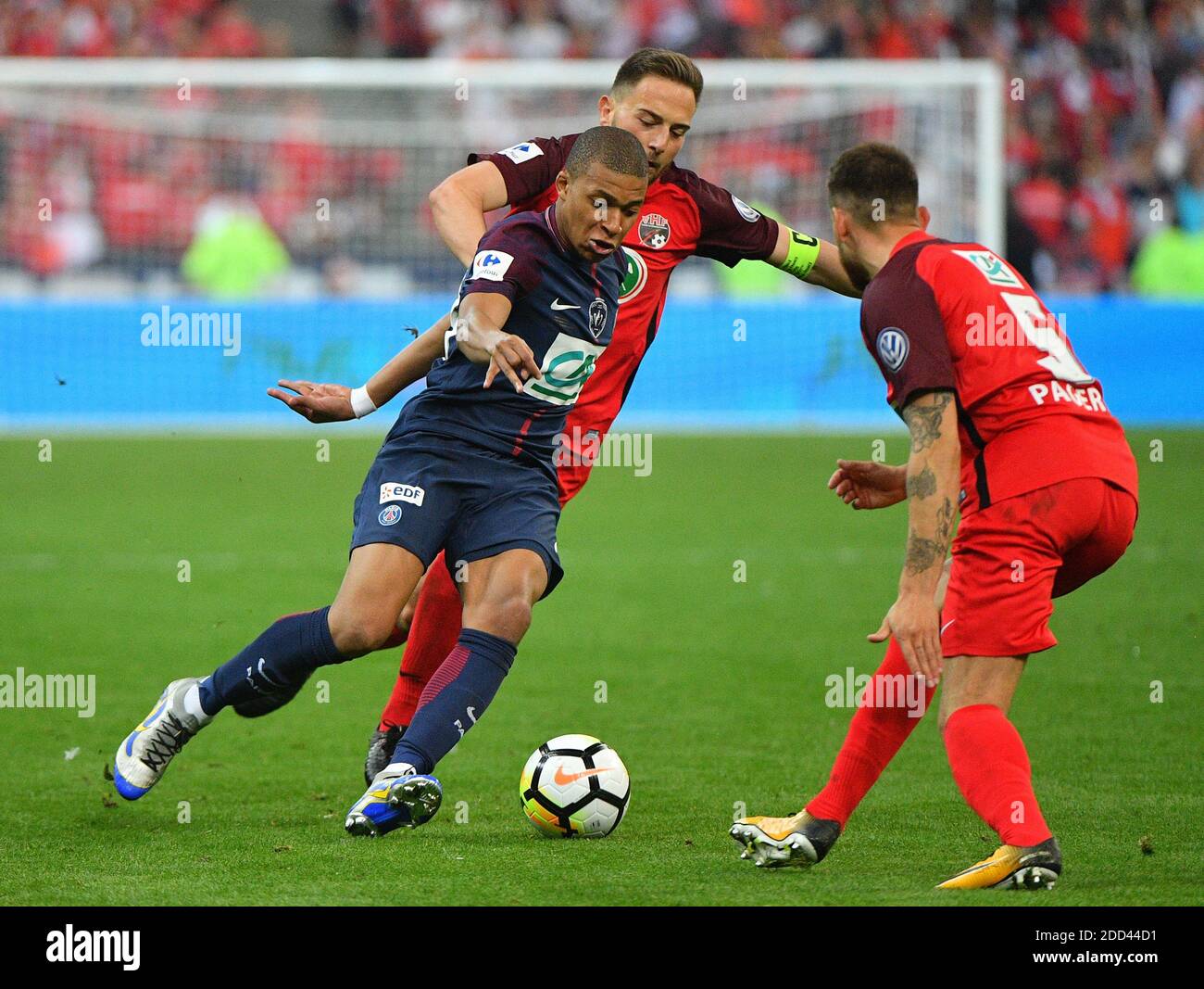 Paris Saint-Germain's French forward Kylian Mbappé (R) kicks the ball ...