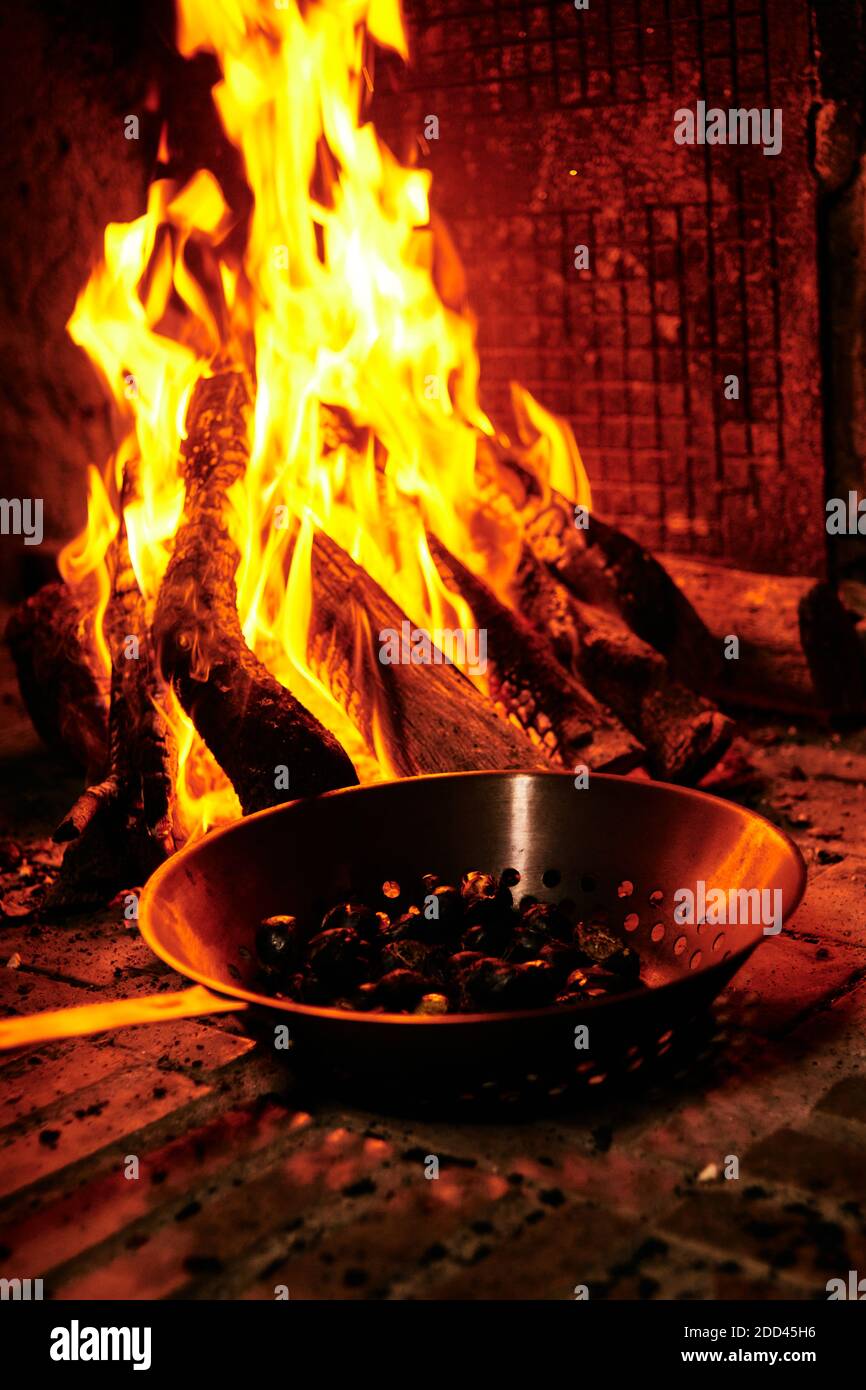 chestnuts roasting over the fire in a typical frying pan over a ...