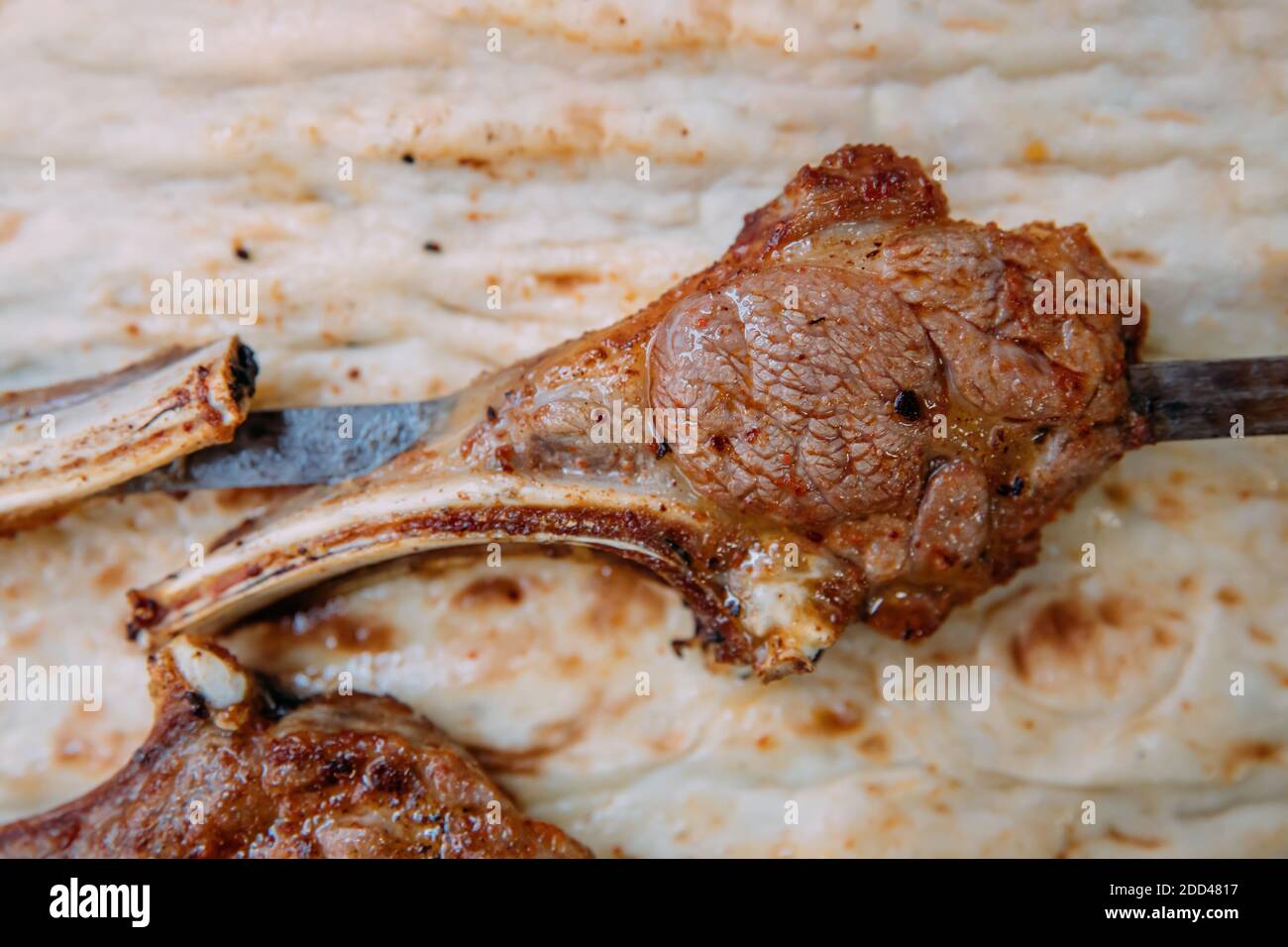 Grilled or barbecued lamb chop meat steaks on the black background ...