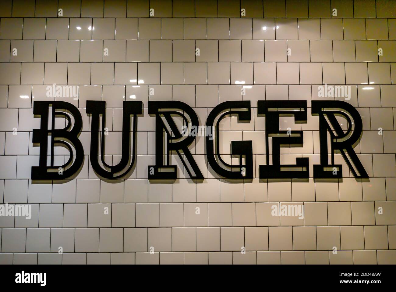 Burgers lettering signage in black letters on the Ceramic tile floor ...